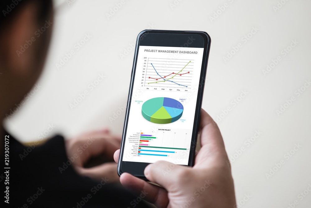 Stock-Foto „Project management dashboard concept. Man hand holding ...