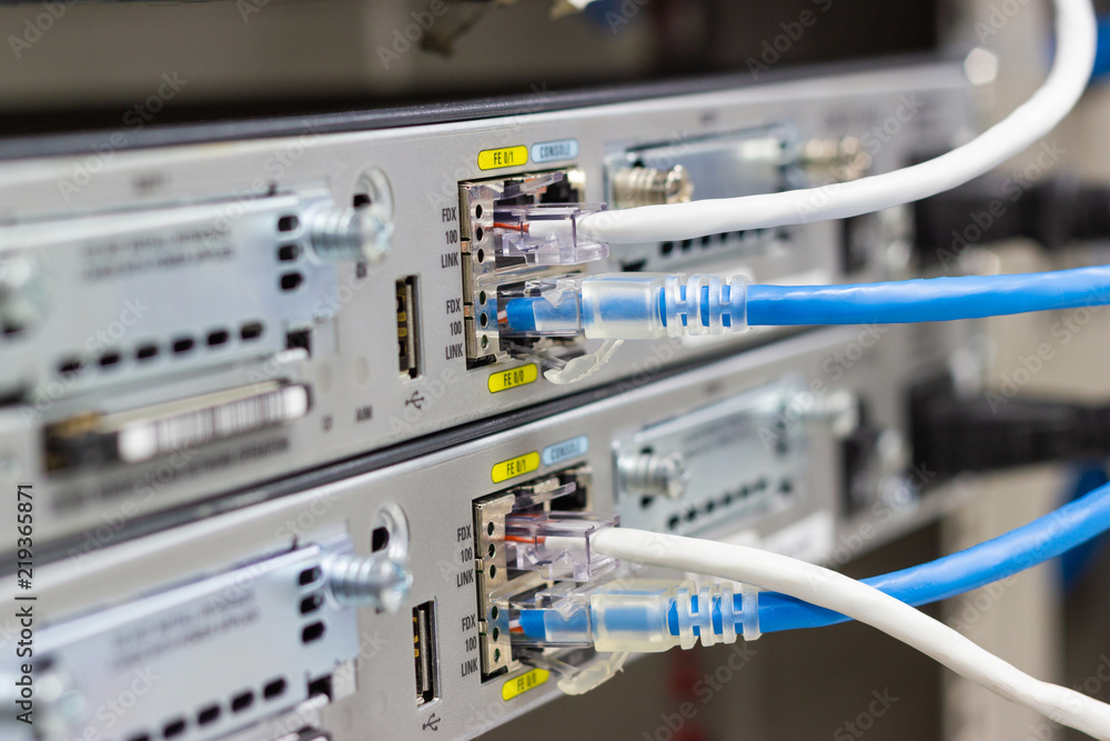 Network switch in rack, network cables connect SFP module port in the ...