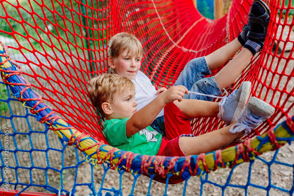 Two blond scandinavian child boy siblings different age lying and ...