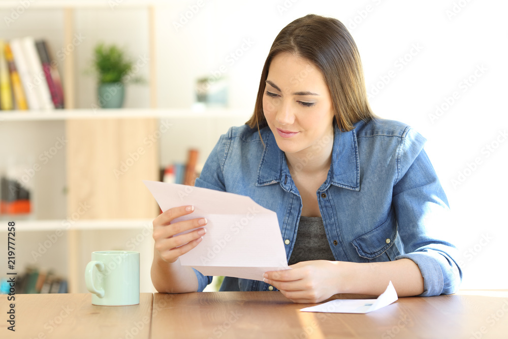 Relaxed lady reading a letter at home Stock Photo | Adobe Stock