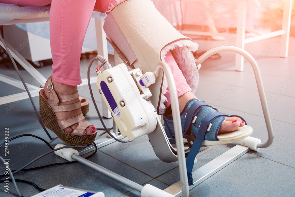 Patient on CPM (continuous passive range of motion) machines. Device to ...