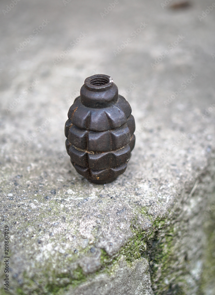 Neutralized grenade of the Second World War on a concrete background of ...