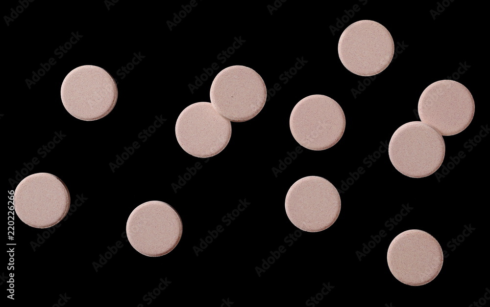 Foto de Stock Pink pills, calcium tablets isolated on black background ...