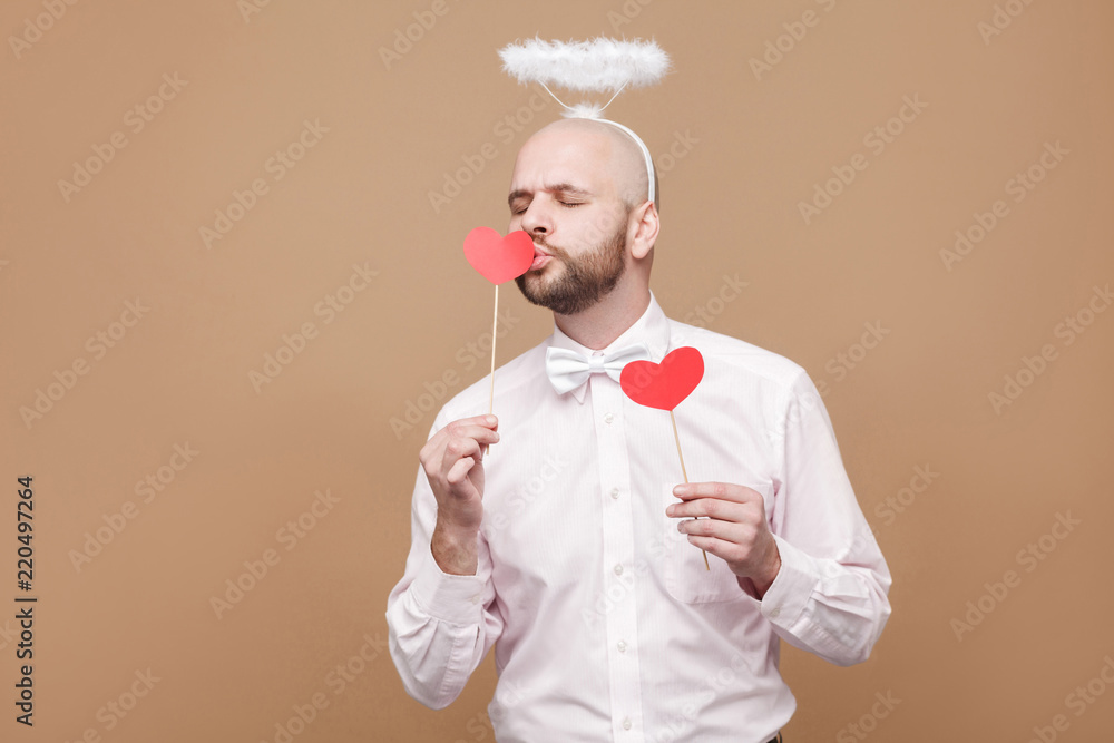 Happy handsome middle aged bald bearded angel in shirt and white halo ...