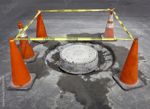 A barricade of caution tape and safety cones mark off maintenance of ...