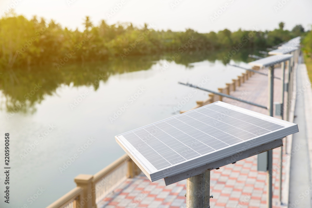 Solar cell plate on the walk way beside the river. solar energy for ...