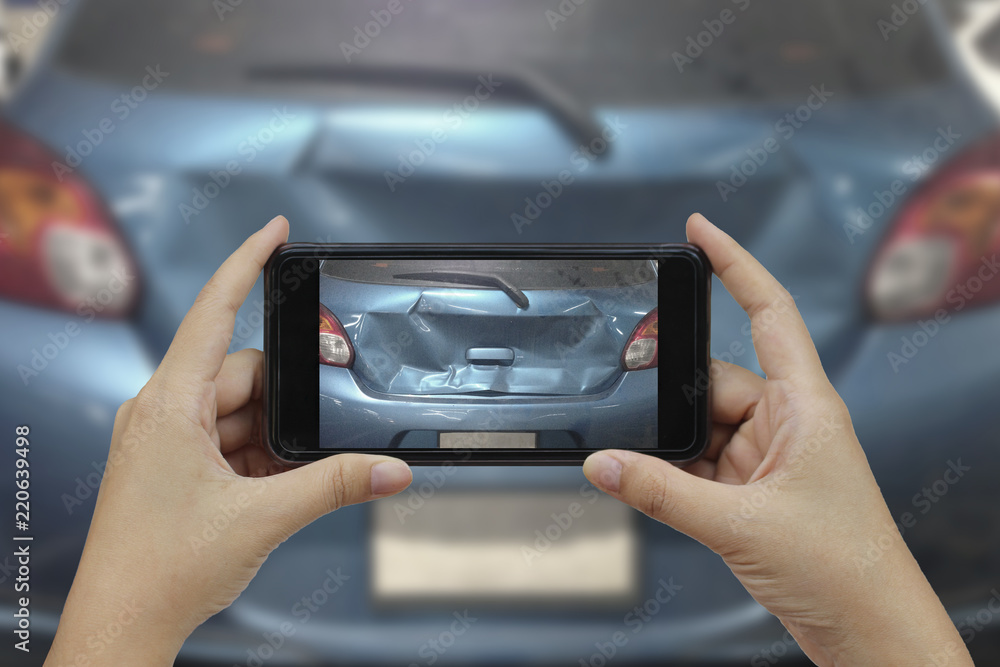 Hand holding smart phone take a photo at The scene of a car crash, car ...