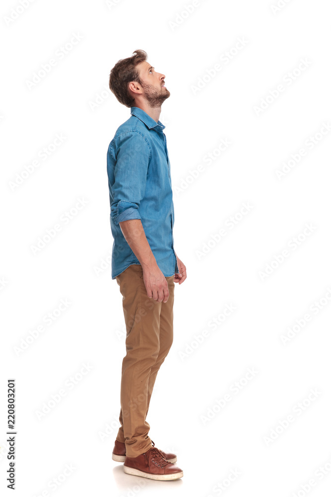 side view of a casual man looking up at something Stock Photo | Adobe Stock