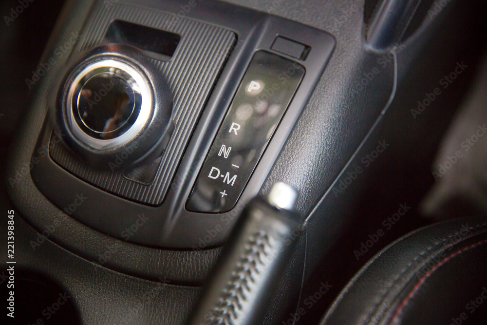 automatic gear stick and dial gear shift control inside the car ...