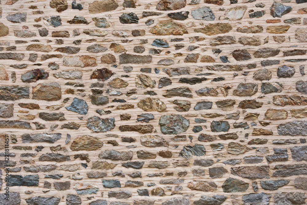 Multi-colored stone wall texture with mortar Stock Photo | Adobe Stock