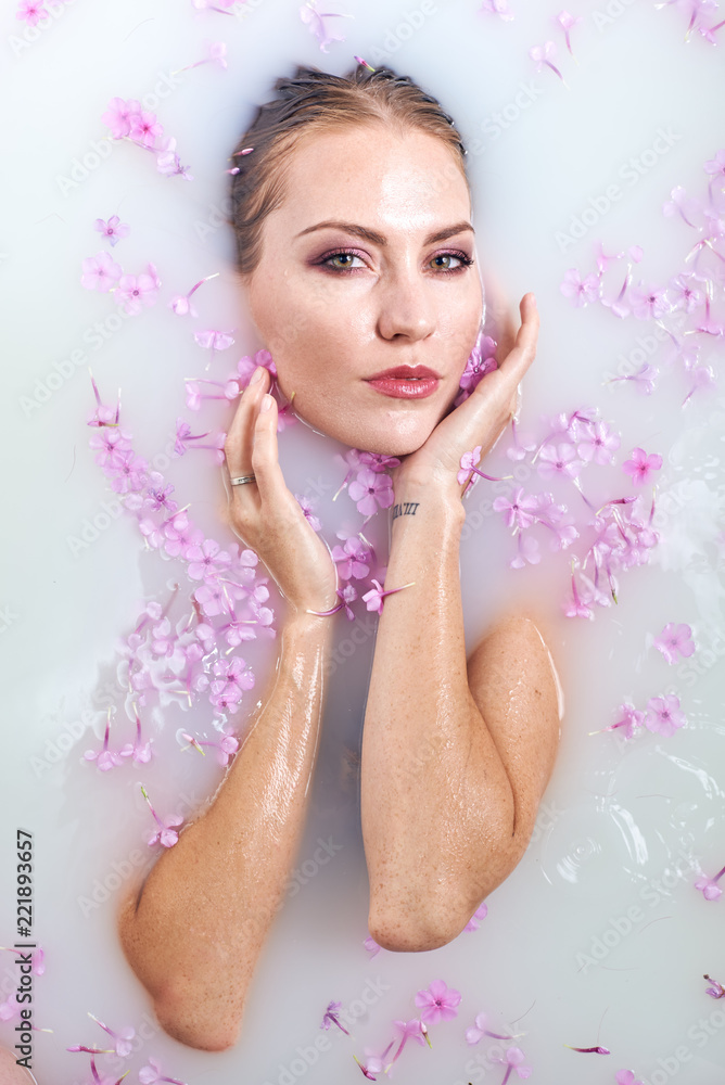 Spa beauty model girl bathing in milk bath, spa and skin care concept ...