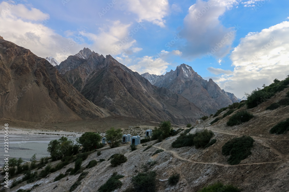 Oasis of green trees on the way to K2 base camp, Trekking along in the ...