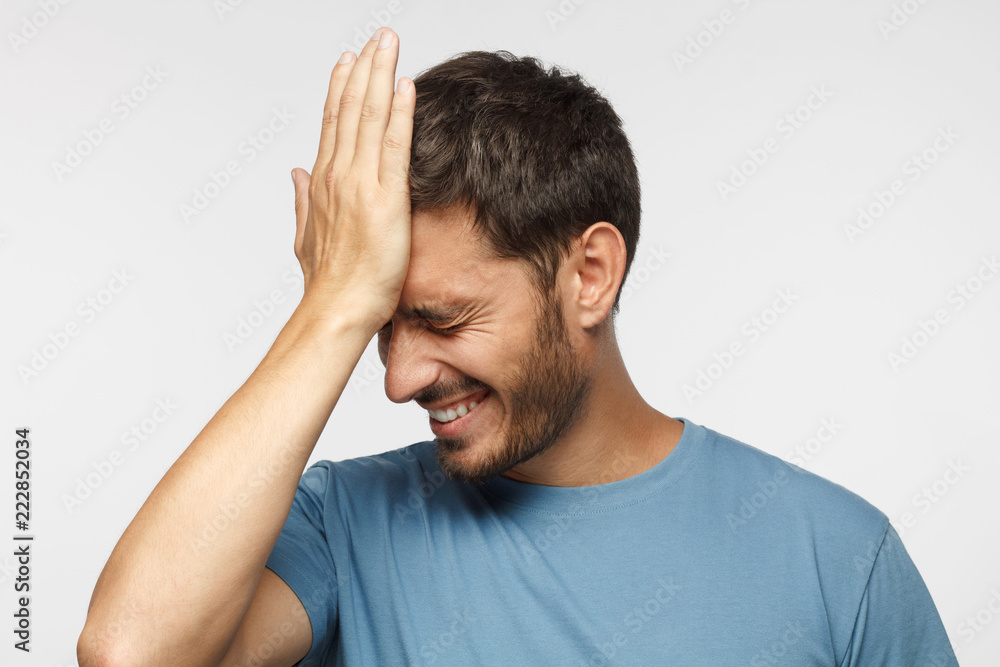 Face palm concept. Stressed out young guy making facepalm gesture with ...