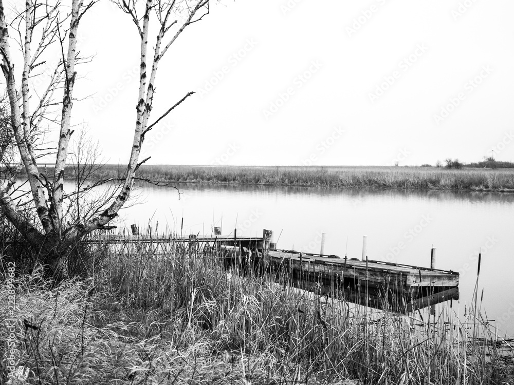 Beautiful picturesque outdoor scene of an old wooden pier sticking out ...