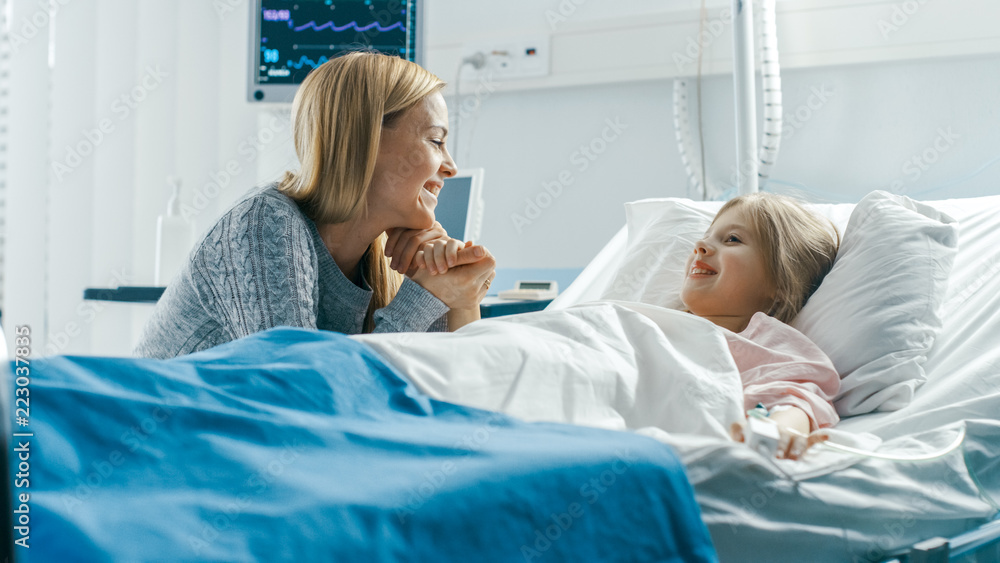 Cute Little Girl Lies on a Bed in the Children's Hospital, Her Mother ...