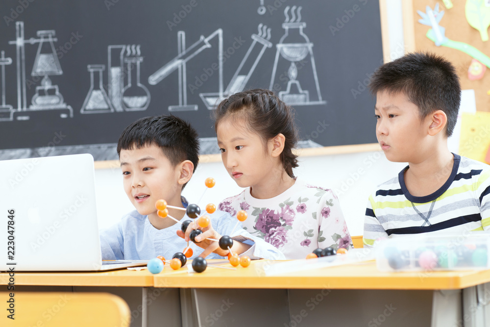 Elementary school students use computers in the classroom Stock Photo ...