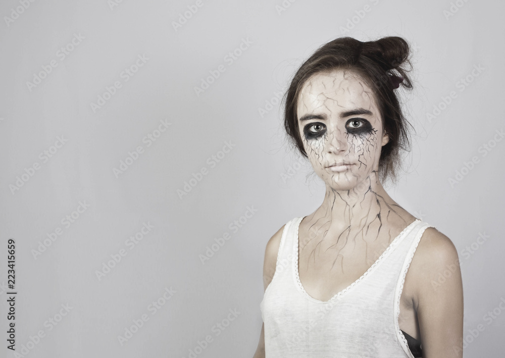 Halloween. Portrait of a sad girl with bruises under her eyes, black ...