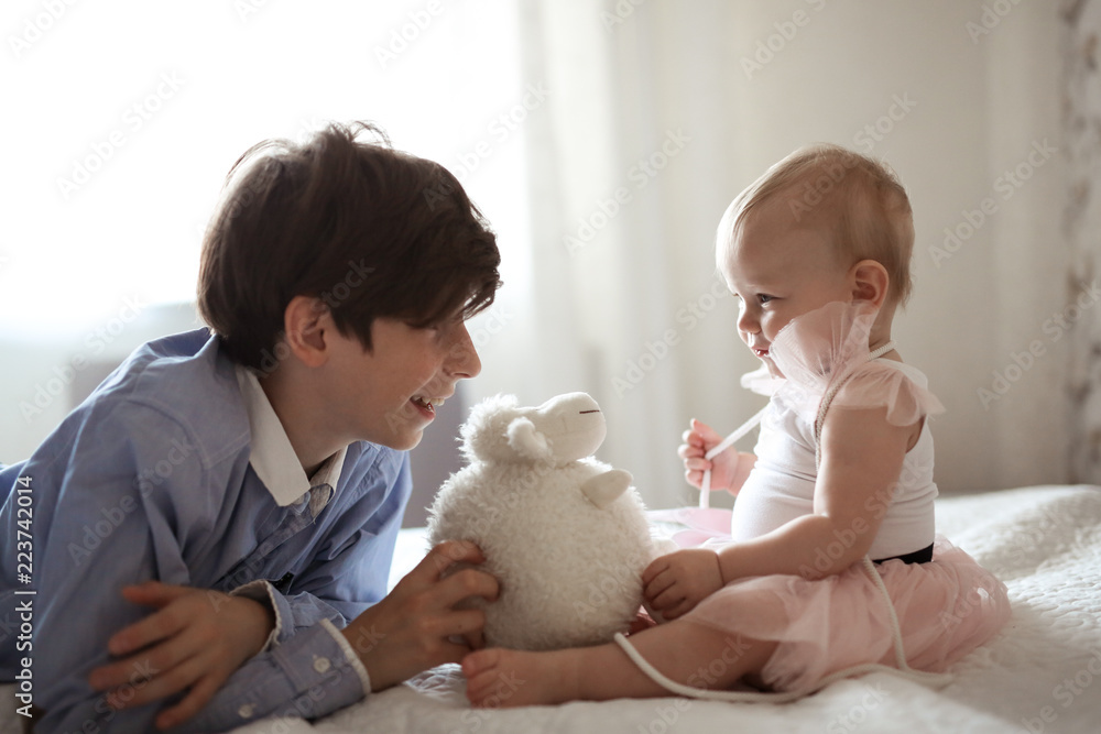 elder brother and sister with soft toy, childhood Stock Photo | Adobe Stock