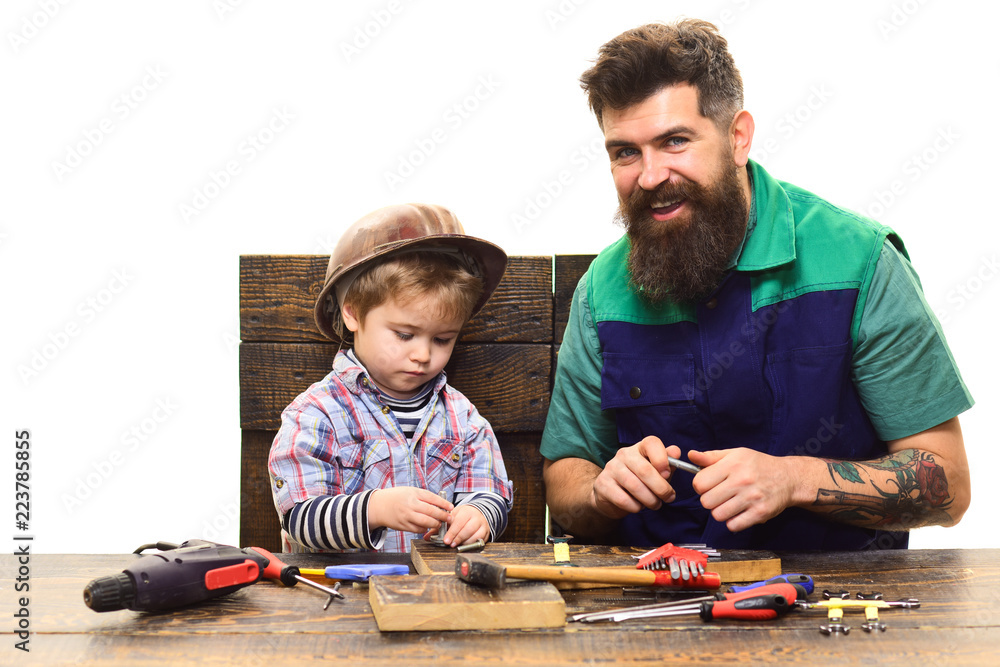 Metal fasteners. Steel bolt and nut. Toddler plays as auto mechanic ...