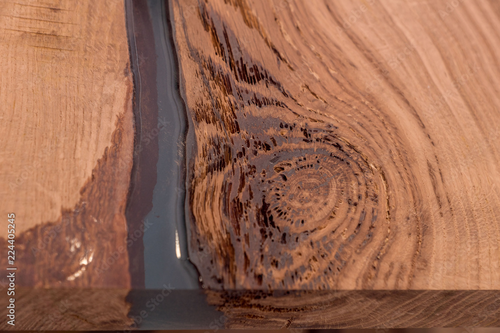 Epoxy resin in cracked walnut massif. Artistic processing of wood ...