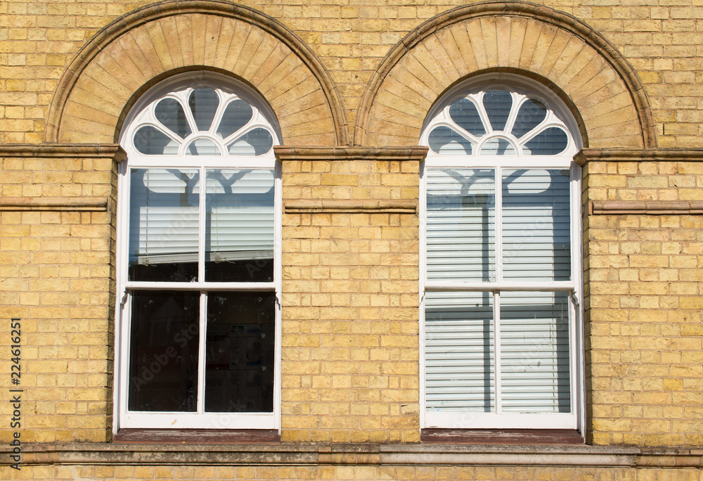 Two Victorian wooden frame white sash window with glass panels on a ...