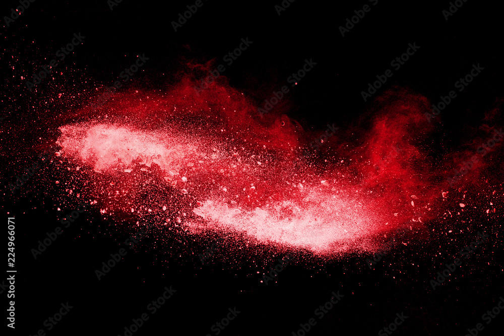 Red color powder explosion on black background.Freeze motion of red ...