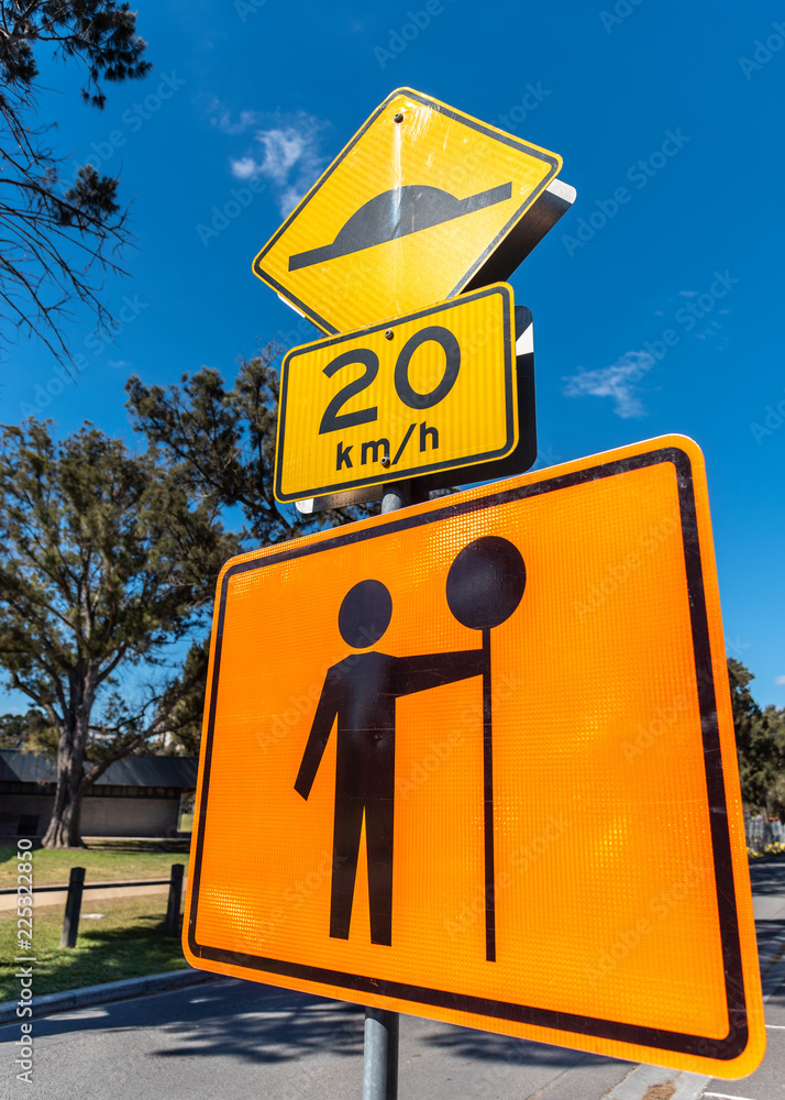Australian road signs "speed bump" "20km/h speed limit" and "person ...