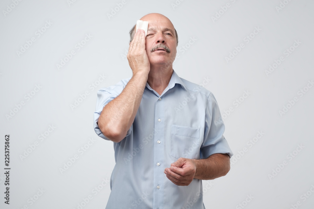 Stock-Foto „Tired old man with mustache stressed sweating having fever ...