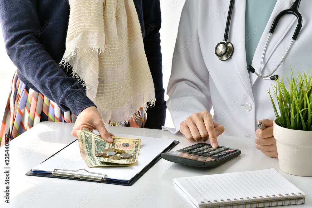 Hospital and medical expense, Doctor and woman patient calculate on ...