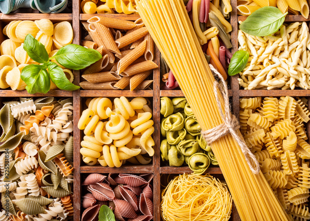 Spaghetti and assorted colorful italian pasta in wooden box. Healthy ...
