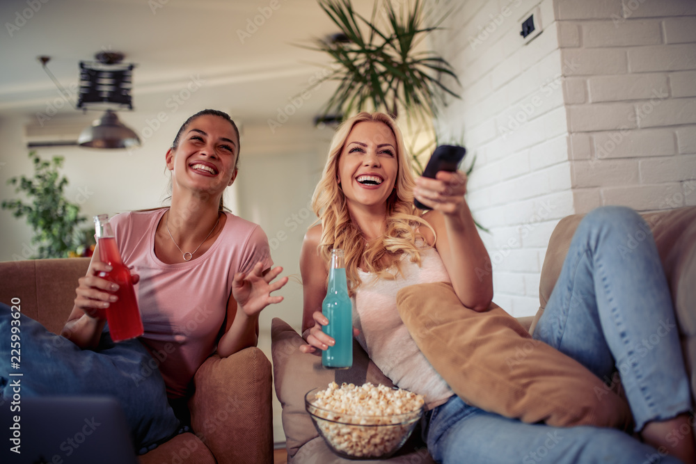 Two girls watching tv together Stock Photo | Adobe Stock