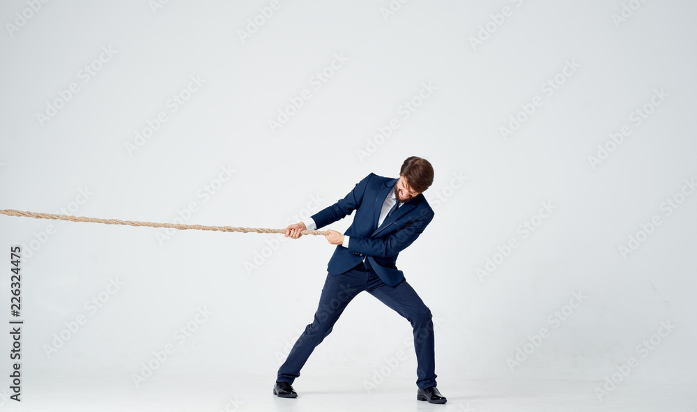 business man pulls the rope Stock Photo | Adobe Stock