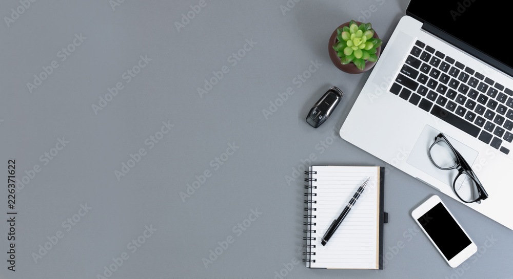 Flat lay view of gray desk with amply copy space for telework or ...