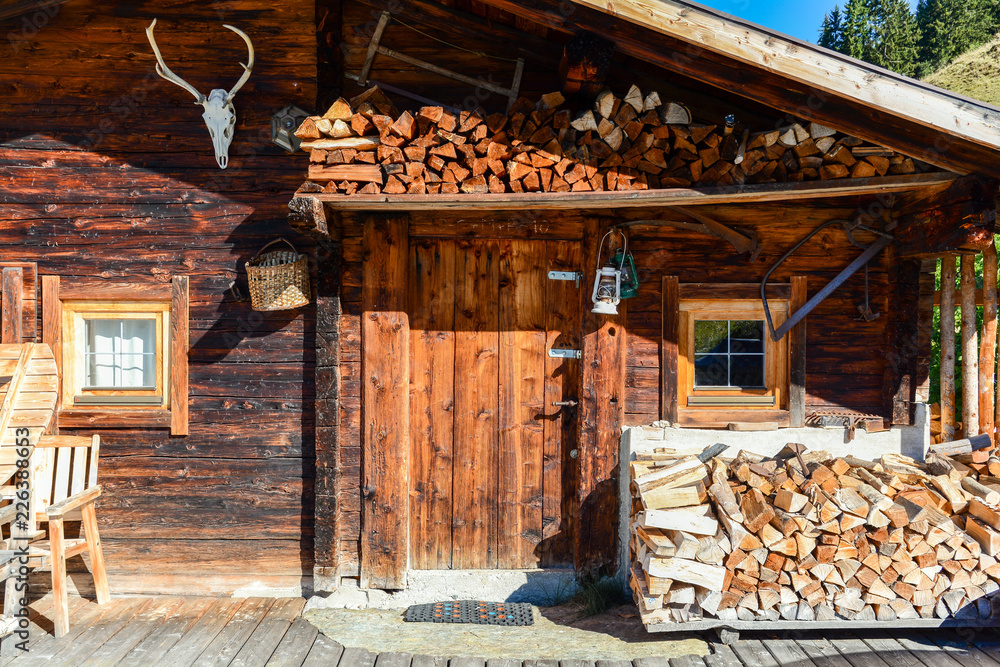 Entrance door to old wooden cabin at mountain meadow in the austrian ...