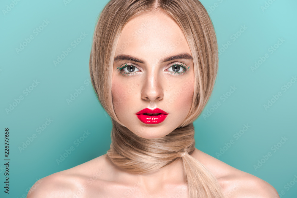 portrait of beautiful young naked woman with long hair around neck looking at camera isolated on ...