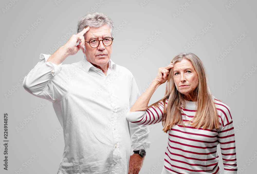 senior cool husband and wife Concentrating hard on an idea, with a ...