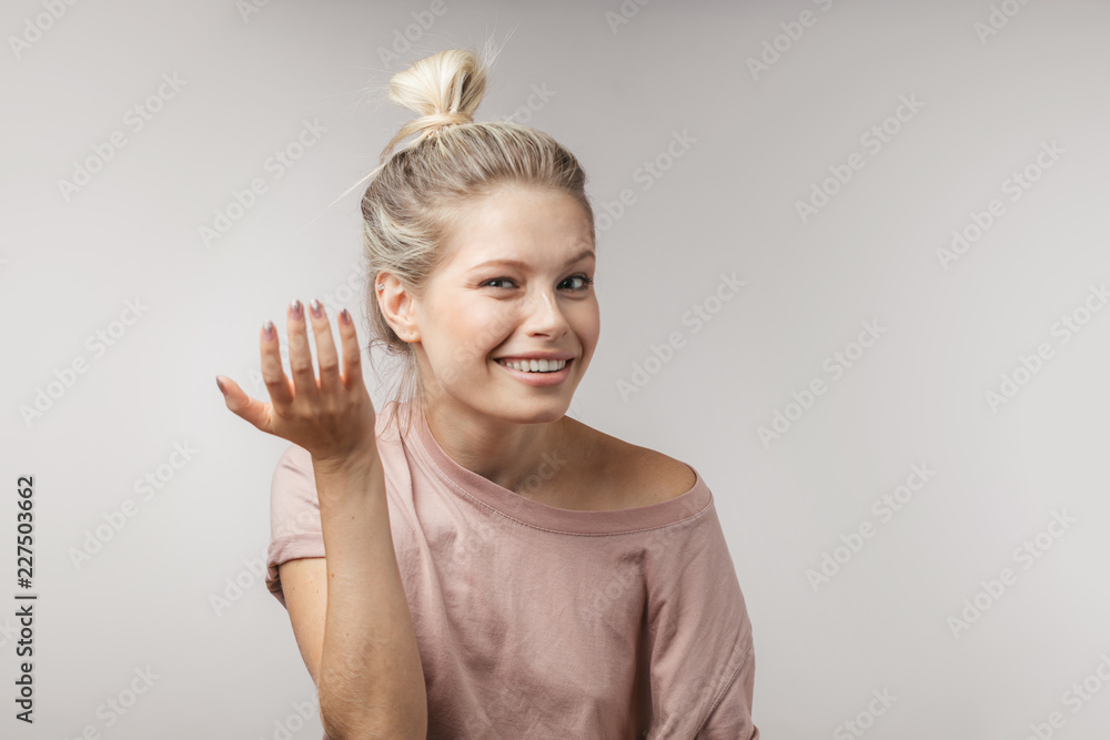 Studio portrait of attractive surprised astonished blonde woman with ...