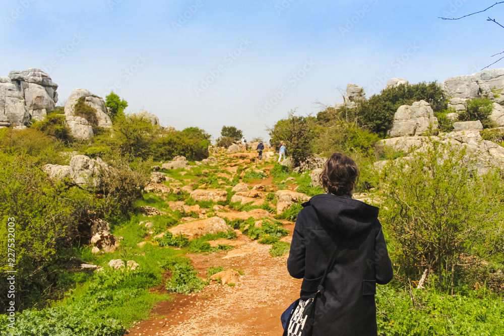 Woman walking on a Prehistoric rare rock formation formed by under sea ...