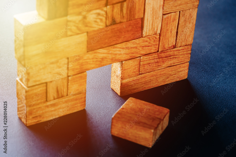 Glowing doorway in the construction of different wooden blocks. Concept ...