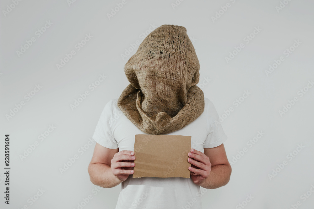 Photo Stock Man with a curtained face on a light background with a ...