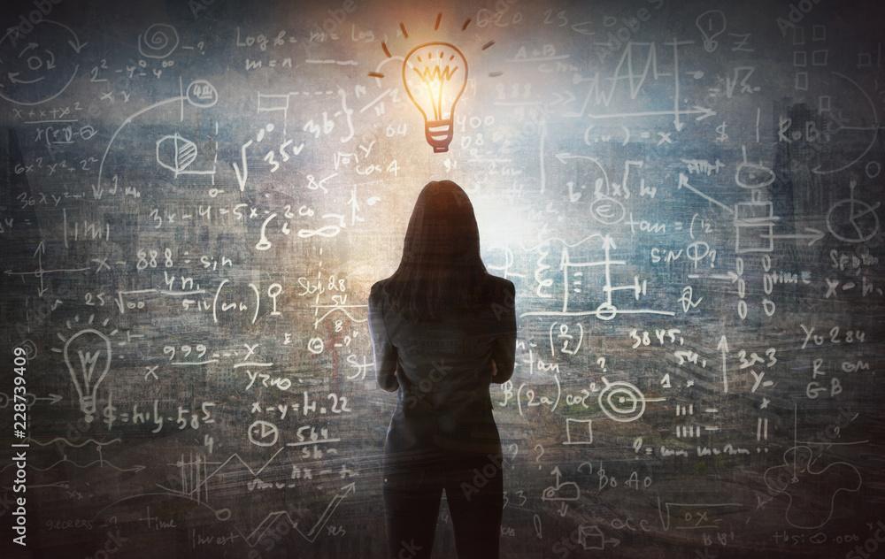 Young woman looking on the black board with mathematical formulas and ...