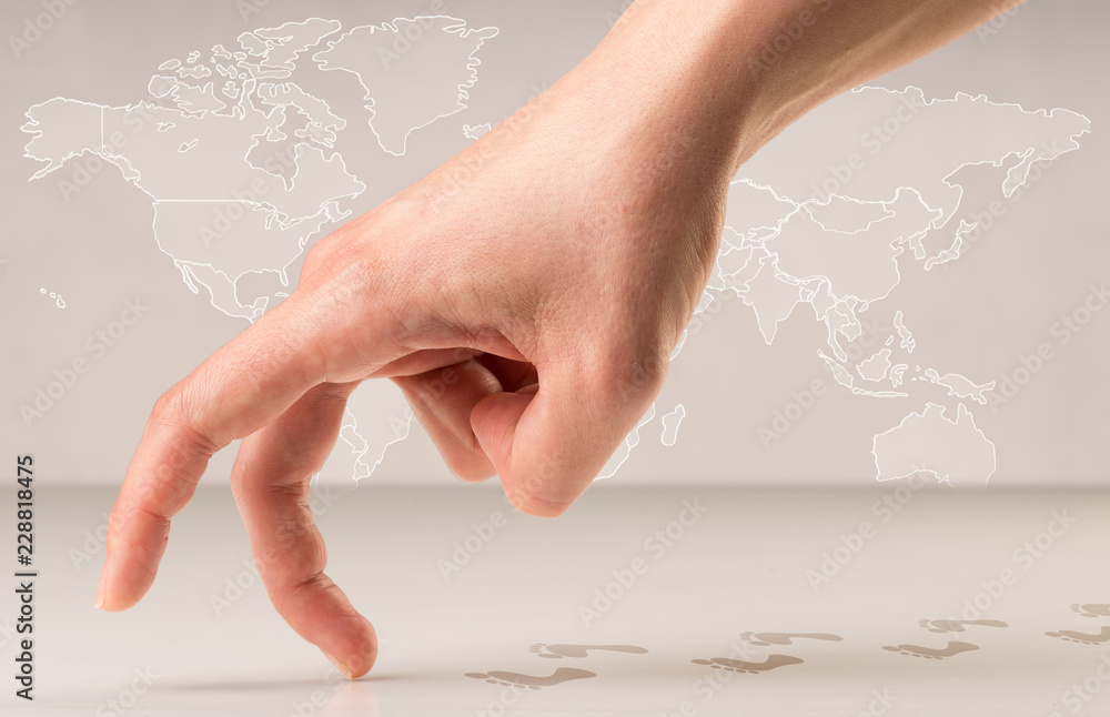 Female fingers walking with footsteps behind them and a world map in ...