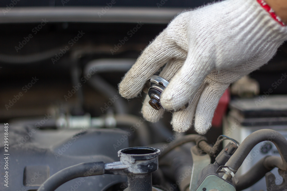 Mechanic man checking radiator cooling tank. Driver check the car ...
