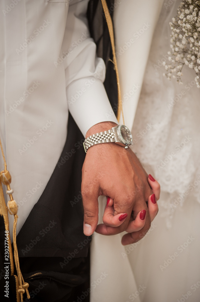 arab groom holds bride's hand Stock Photo | Adobe Stock