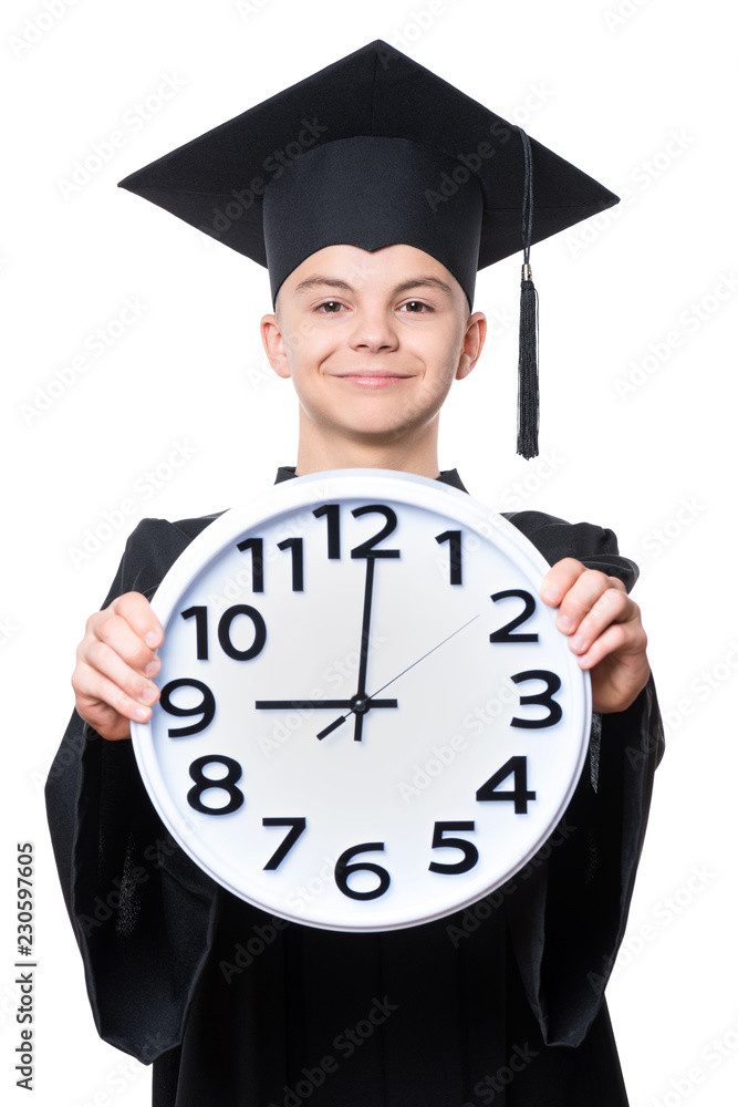 Portrait of graduate teen boy student in black graduation gown with hat ...