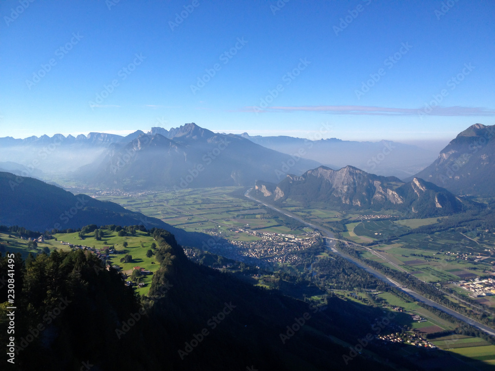 view from a high alpine mountain peak in Switzerland with a great view ...