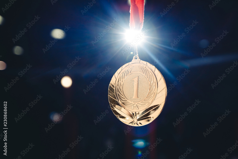 Sport winner gold medal first place in competitions dark background ...