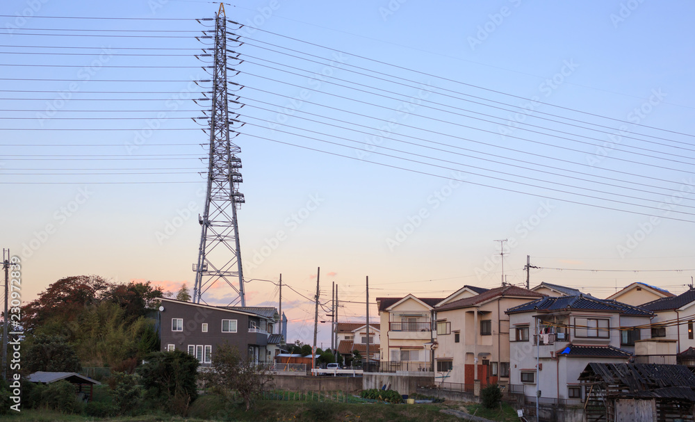 High voltage power lines run from tower in residential neighborhood at ...