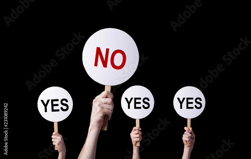 People's hands holding YES and NO signs. Most of them holding a YES ...