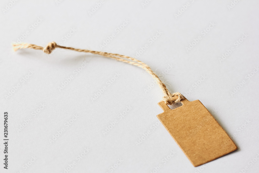 Blank brown cardboard price tag, sale tag, gift tag, address label on ...